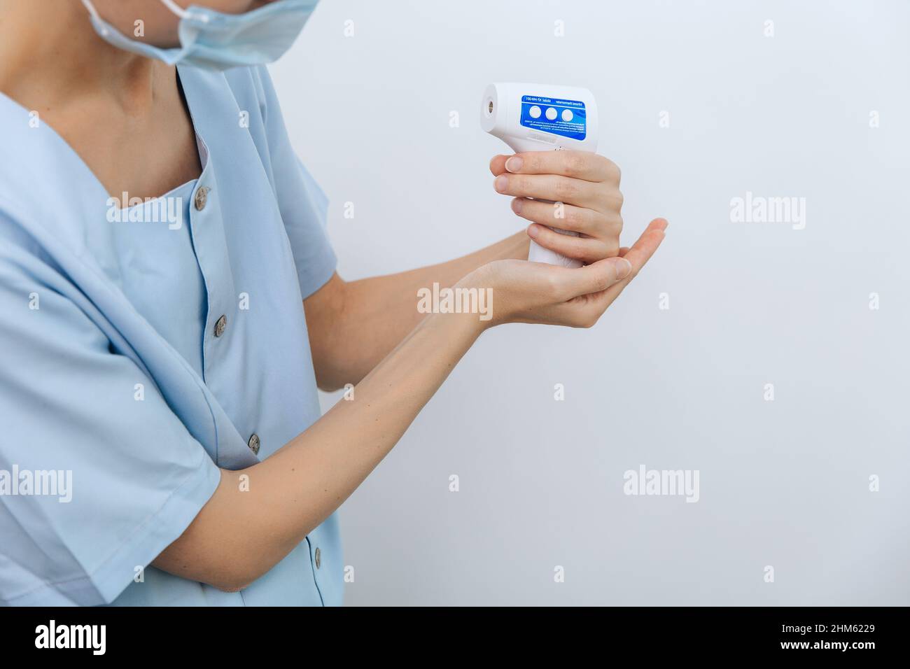 Temperature measurement gun in doctor hands. Close-up shot of doctor ...