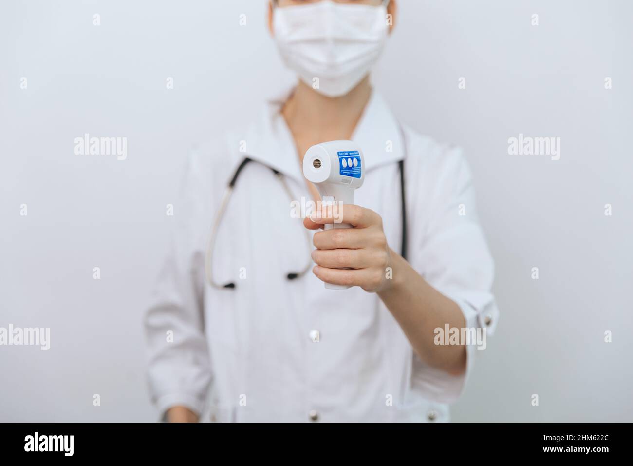 Temperature measurement gun in doctor hands. Close-up shot of doctor ...