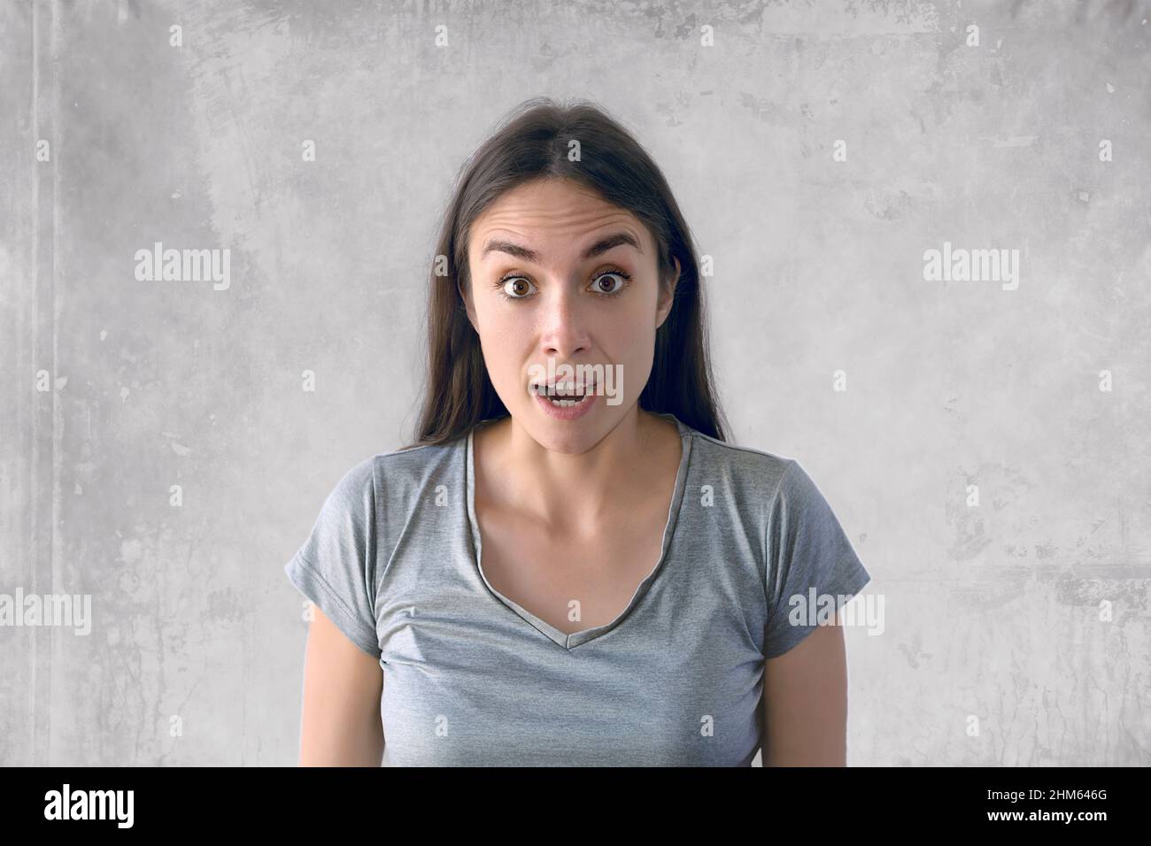 Angry woman screaming on a white concrete background hi-res stock ...