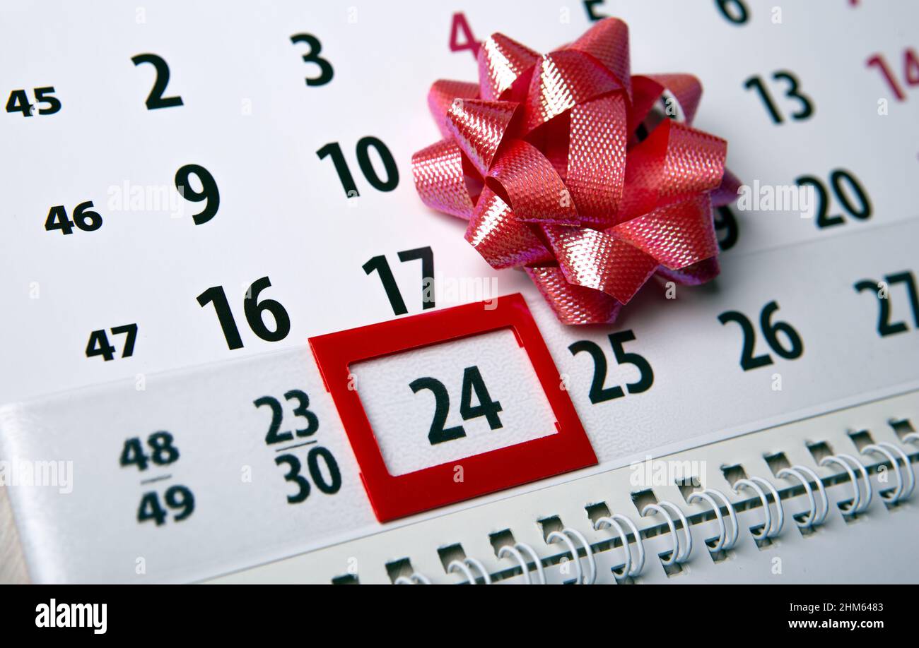 wall calendar with day 24 december and festive bow Stock Photo - Alamy