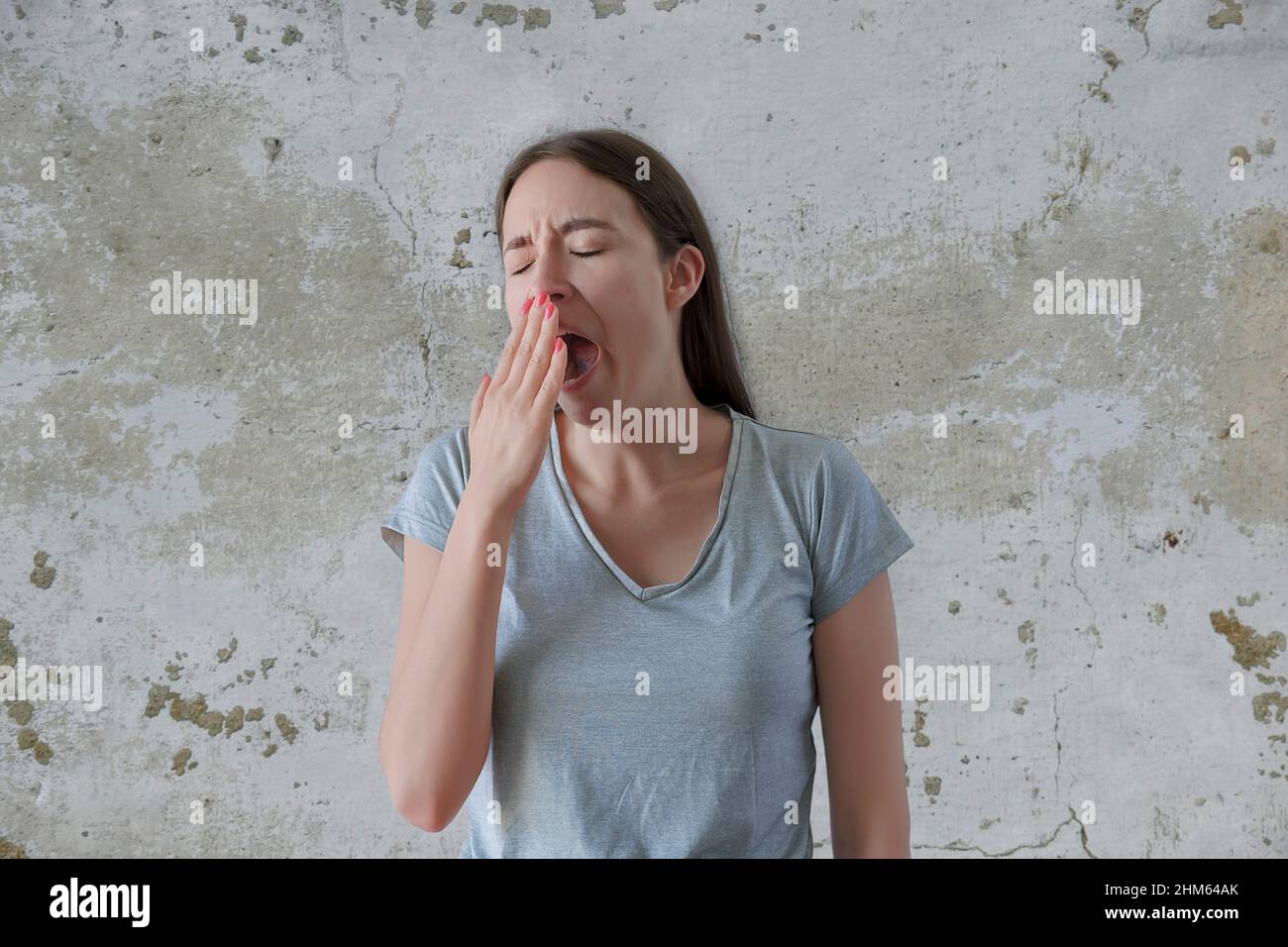 Tired woman yawning covering open mouth with hand need rest Stock Photo ...