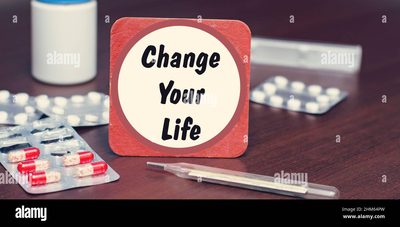 Change your life concept. Text on the background of pills and a medical ...