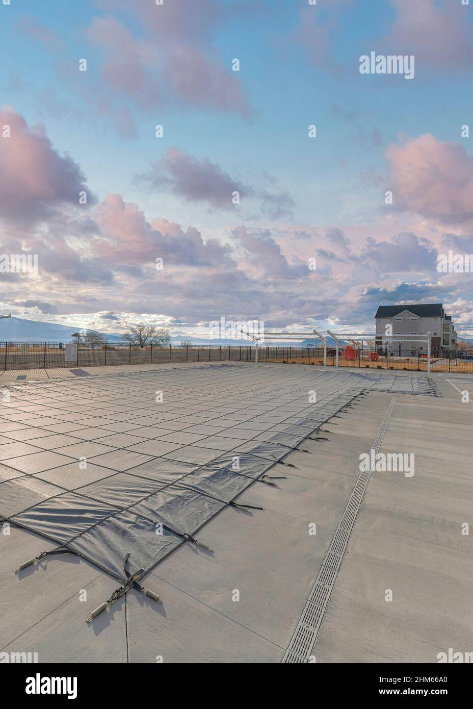 Vertical Puffy clouds at sunset Covered community pool in a residential ...