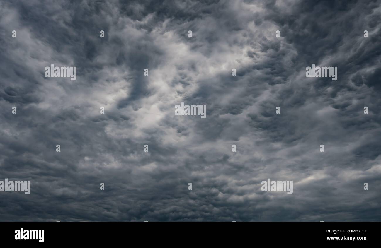 Dramatic rain storm clouds background. Light in Dark Stock Photo - Alamy