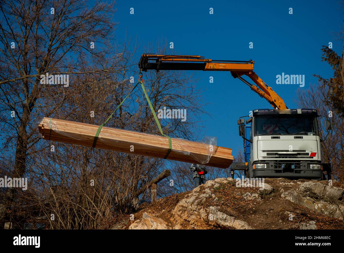 Unloading goods from the truck with a crane Stock Photo - Alamy
