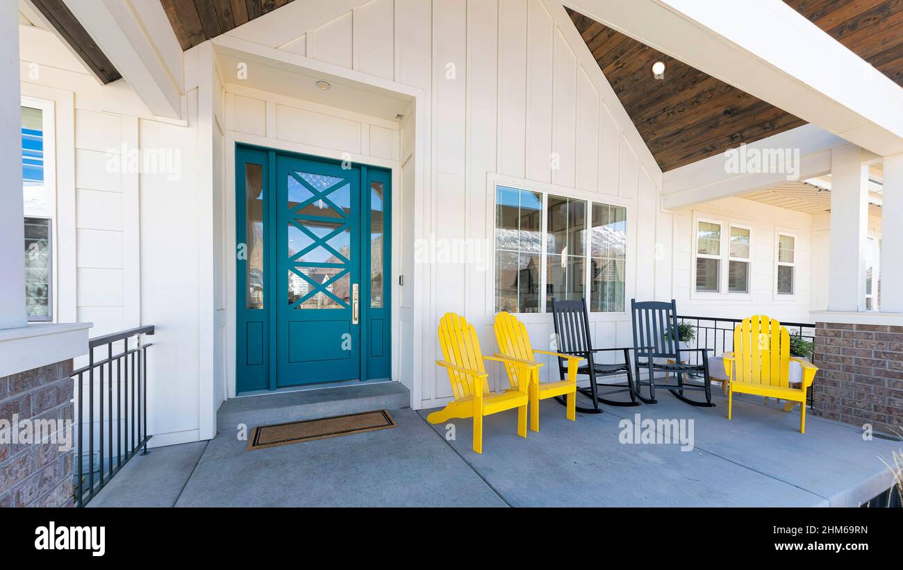 Panorama Porch of a house with blue green door and lounge chairs Stock ...
