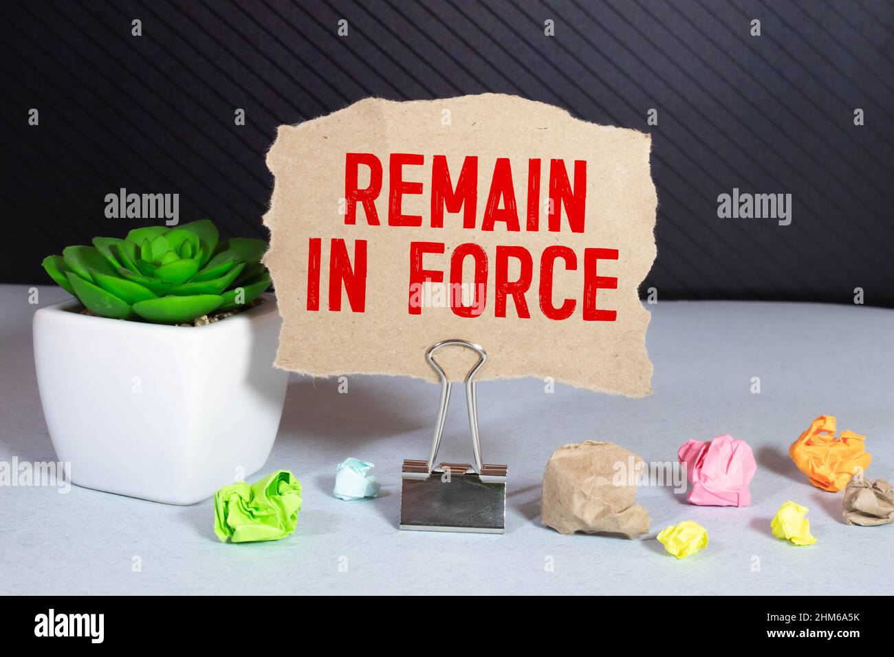 text remain in force on torn paper Stock Photo - Alamy