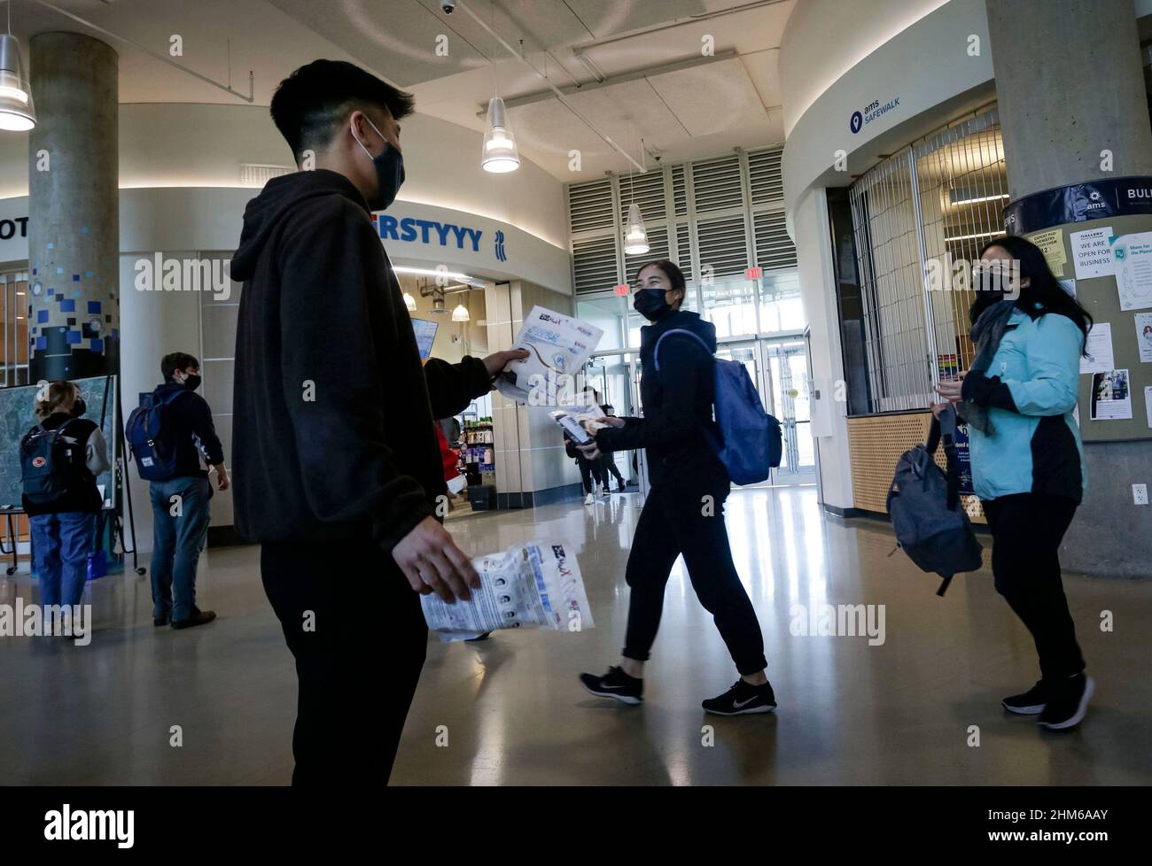 Vancouver, Canada. 7th Feb, 2022. A volunteer distributes KN95 masks at ...