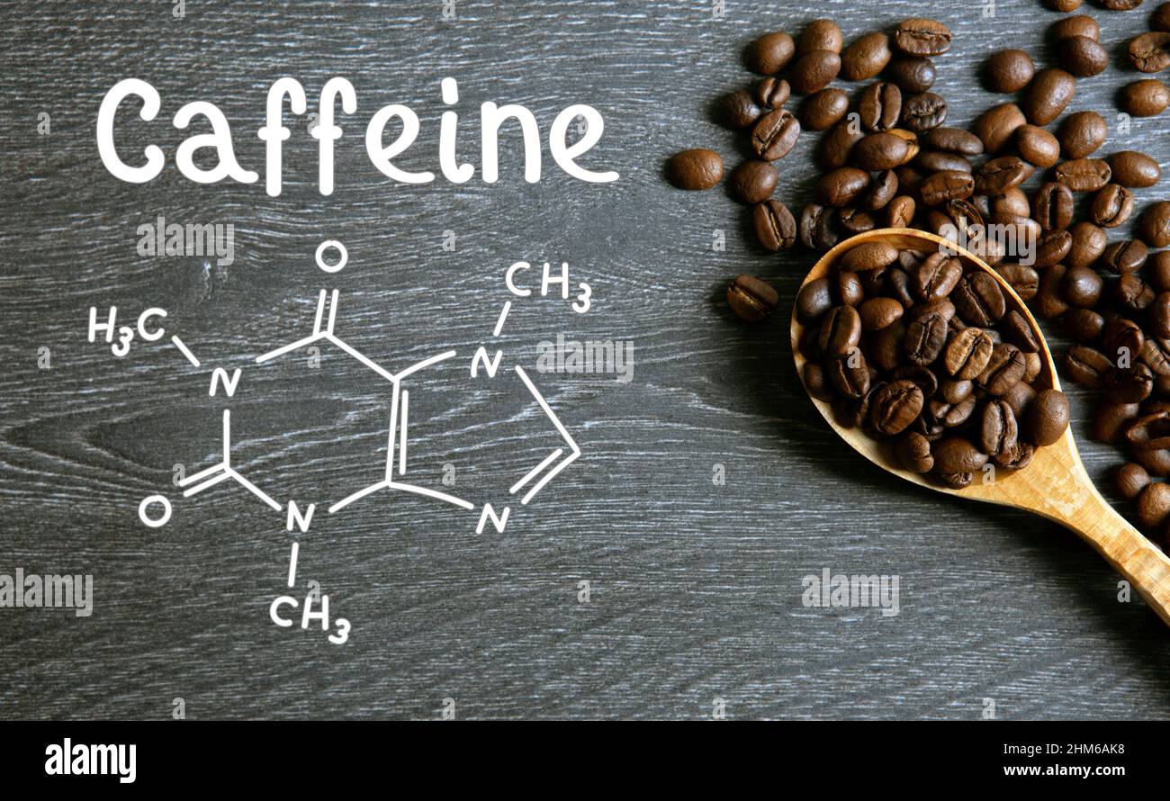 coffee beans with wooden spoon and chemical structure of caffeine on a ...