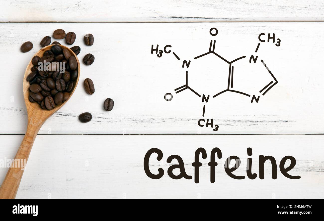 coffee beans with wooden spoon and chemical structure of caffeine on a ...