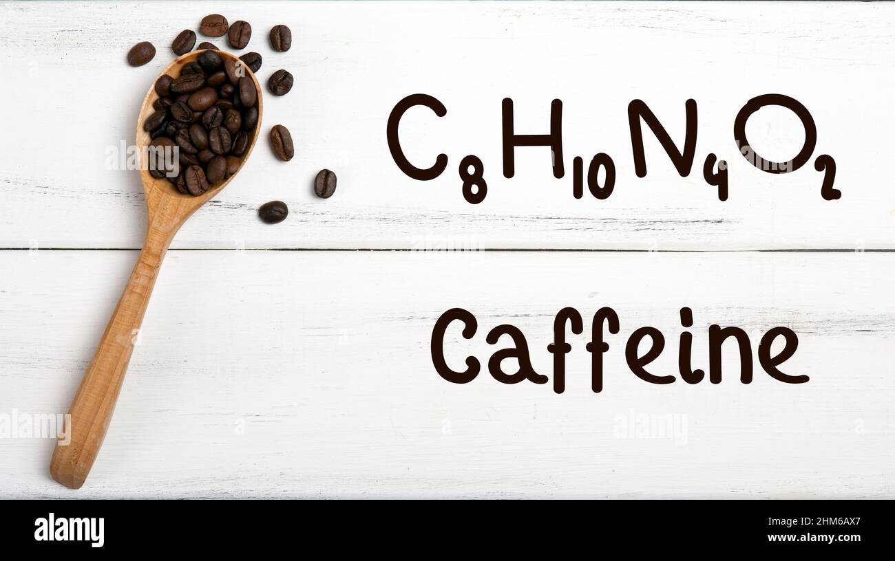 coffee beans with wooden spoon and chemical structure of caffeine on a ...