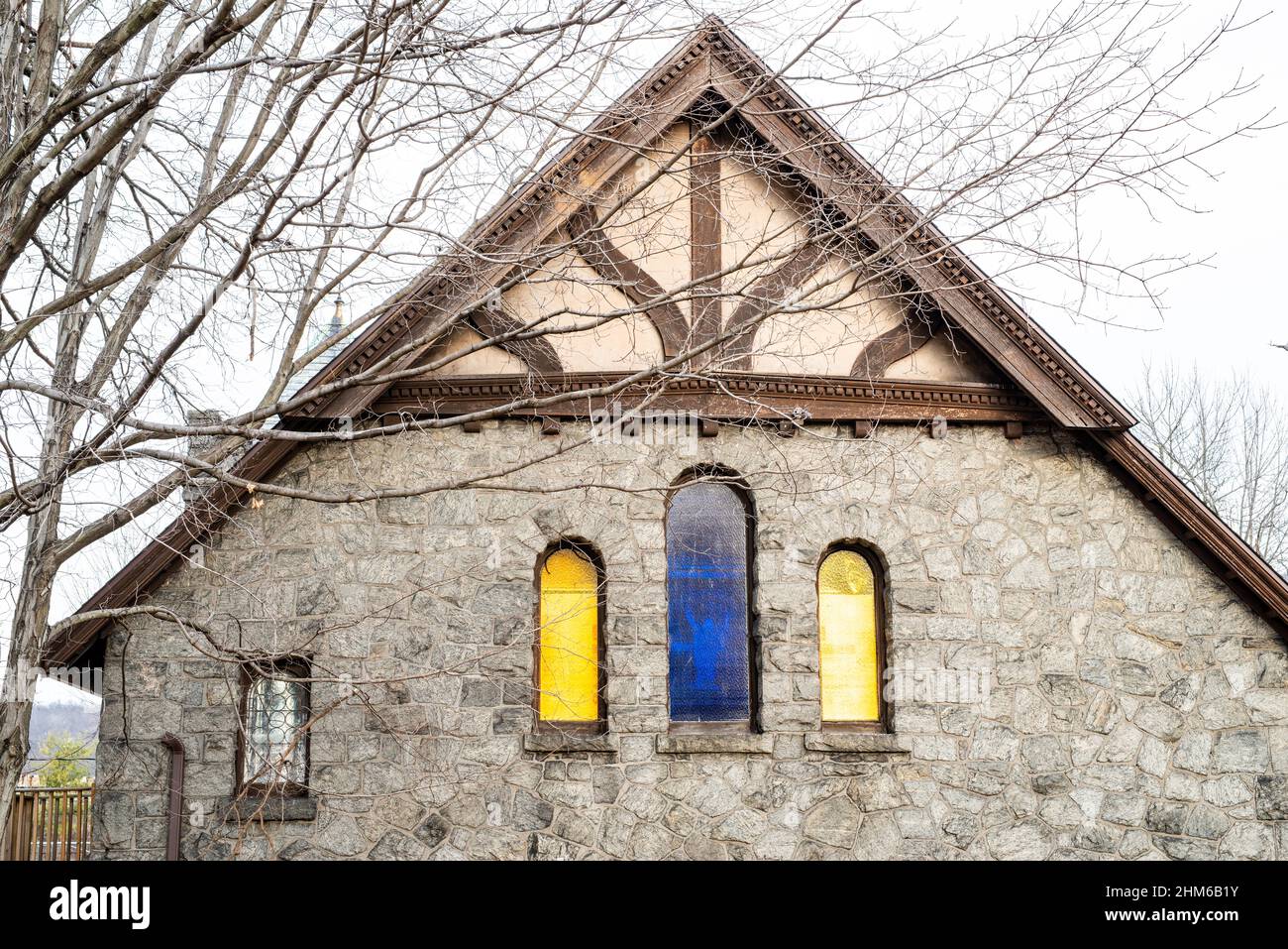 Old Stone Church with windows glowing golden from sunset Stock Photo ...