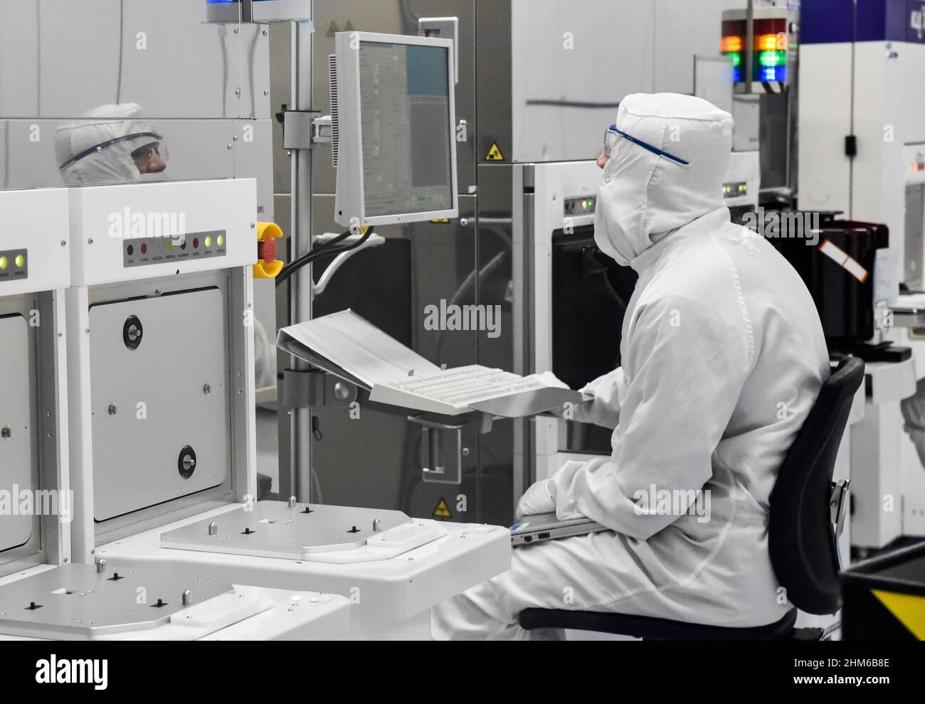 07 February 2022, Belgium, Löwen: An employee sits in a research center ...