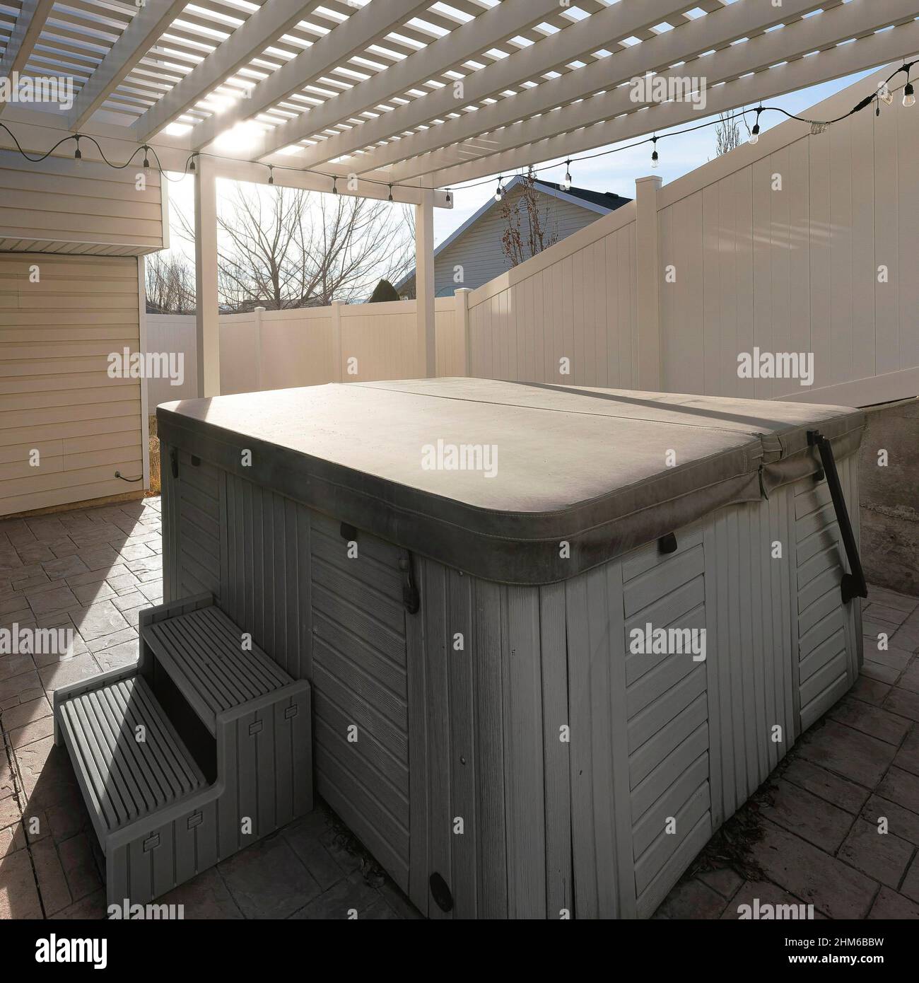 Square Sun flare Covered portable spa pool at the backyard of a house ...