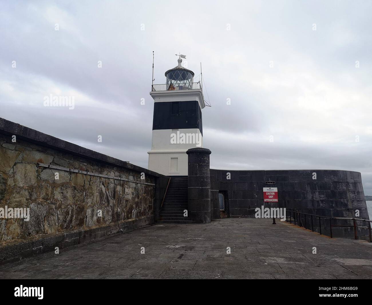 Holyhead Breakwater lighthouse on a concrete pier on a gloomy day Stock ...