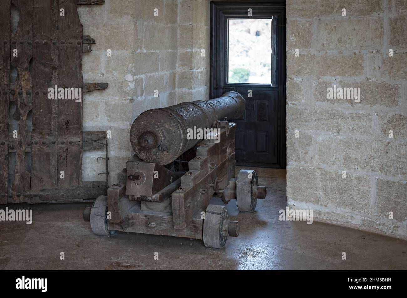Defense cannon facing the window inside of an old castle of the ...