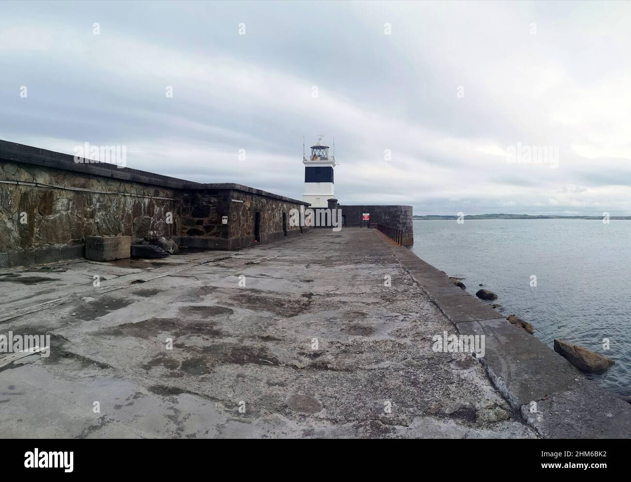 Holyhead Breakwater lighthouse on a concrete pier on a gloomy day Stock ...