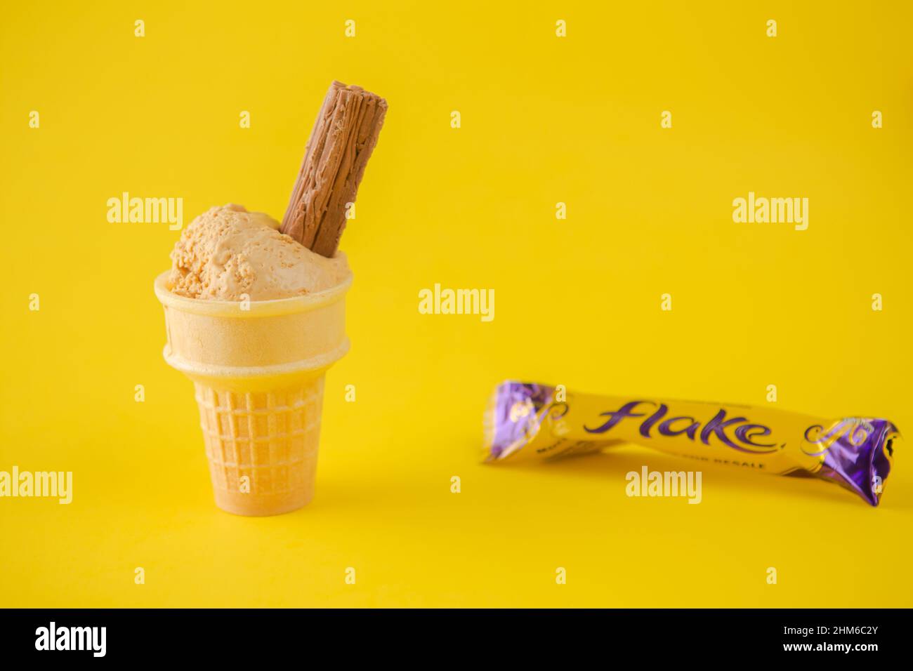 chocolate flake with homemade salty caramel ice cream in a cone against ...