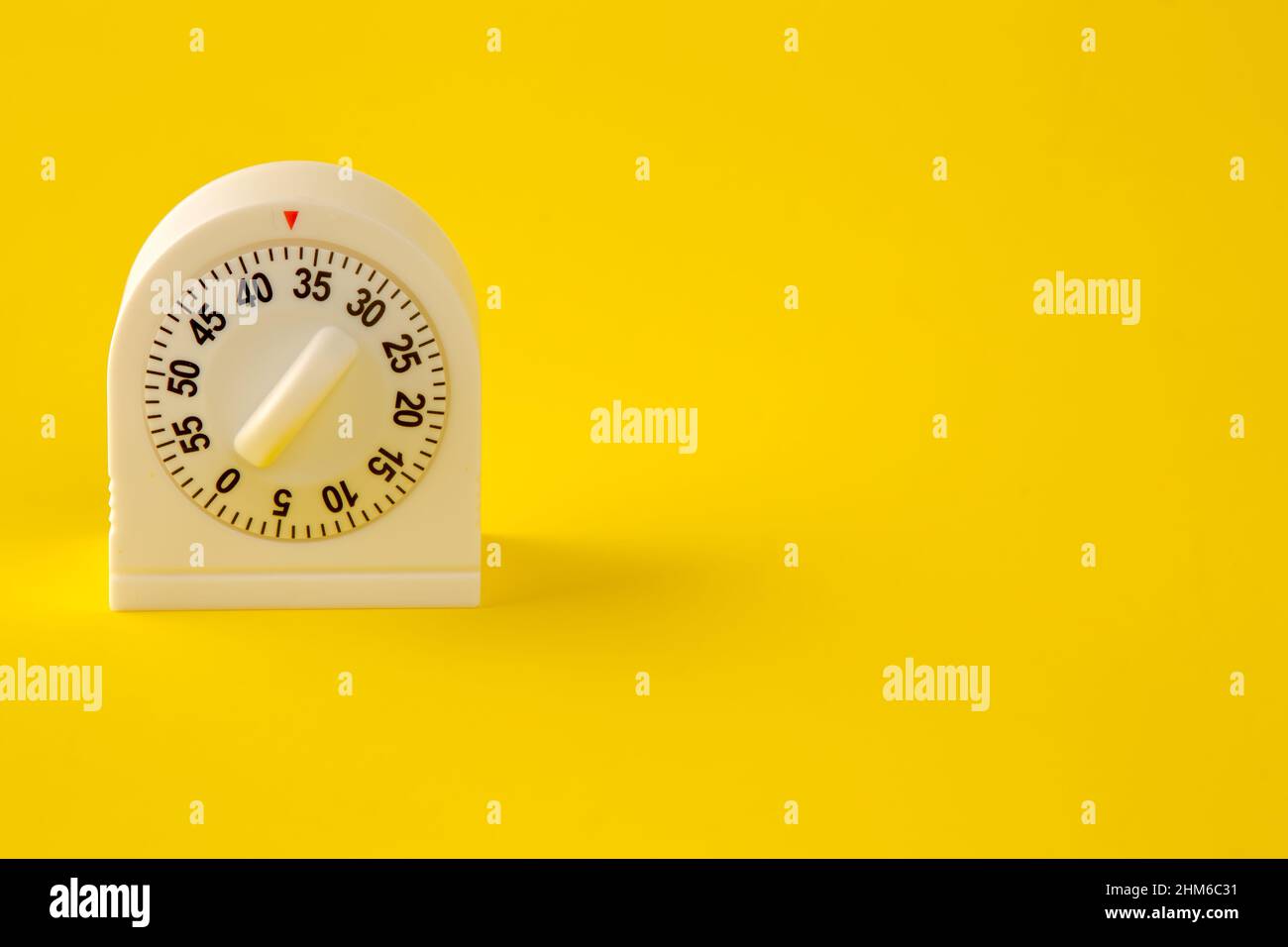 White clockwork timer on a yellow background with copy space Stock ...