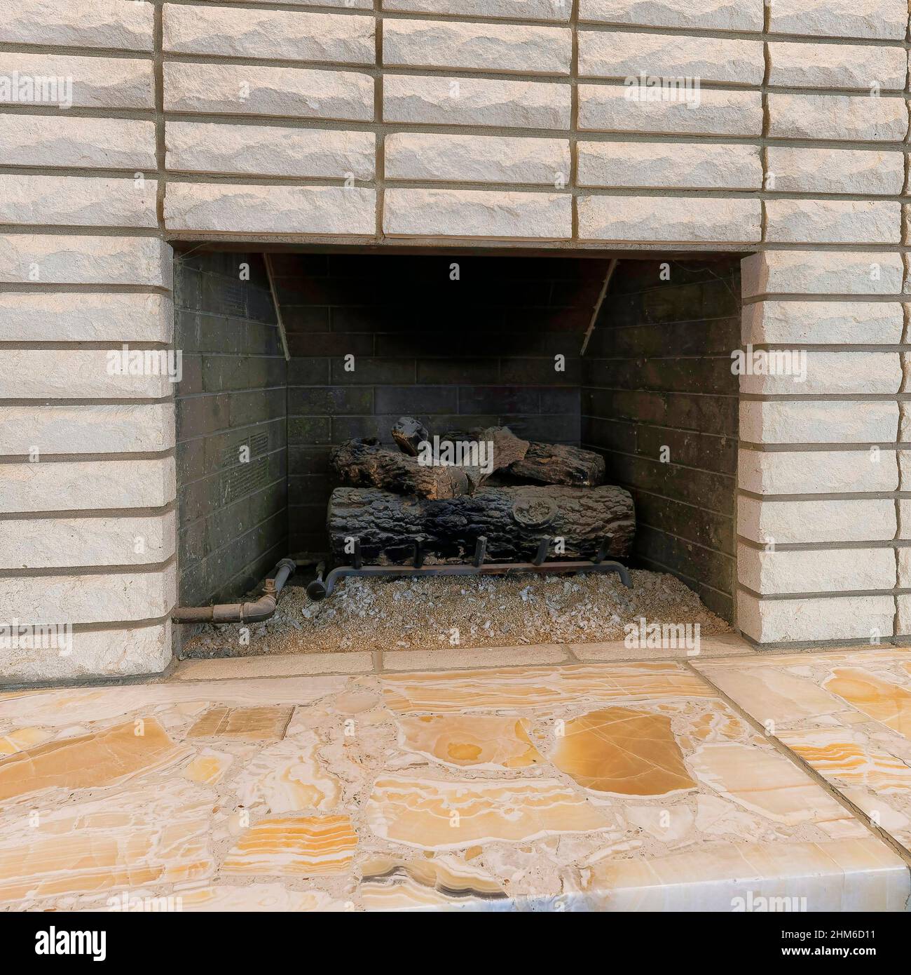 Square Fireplace in a house with slightly burned firewood inside Stock ...
