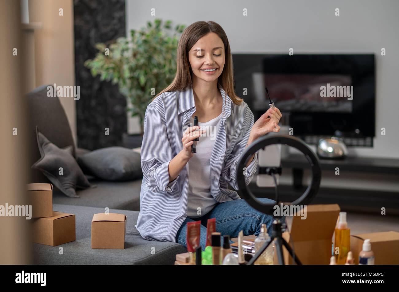 Cute young woman conducting an online tutorial Stock Photo - Alamy
