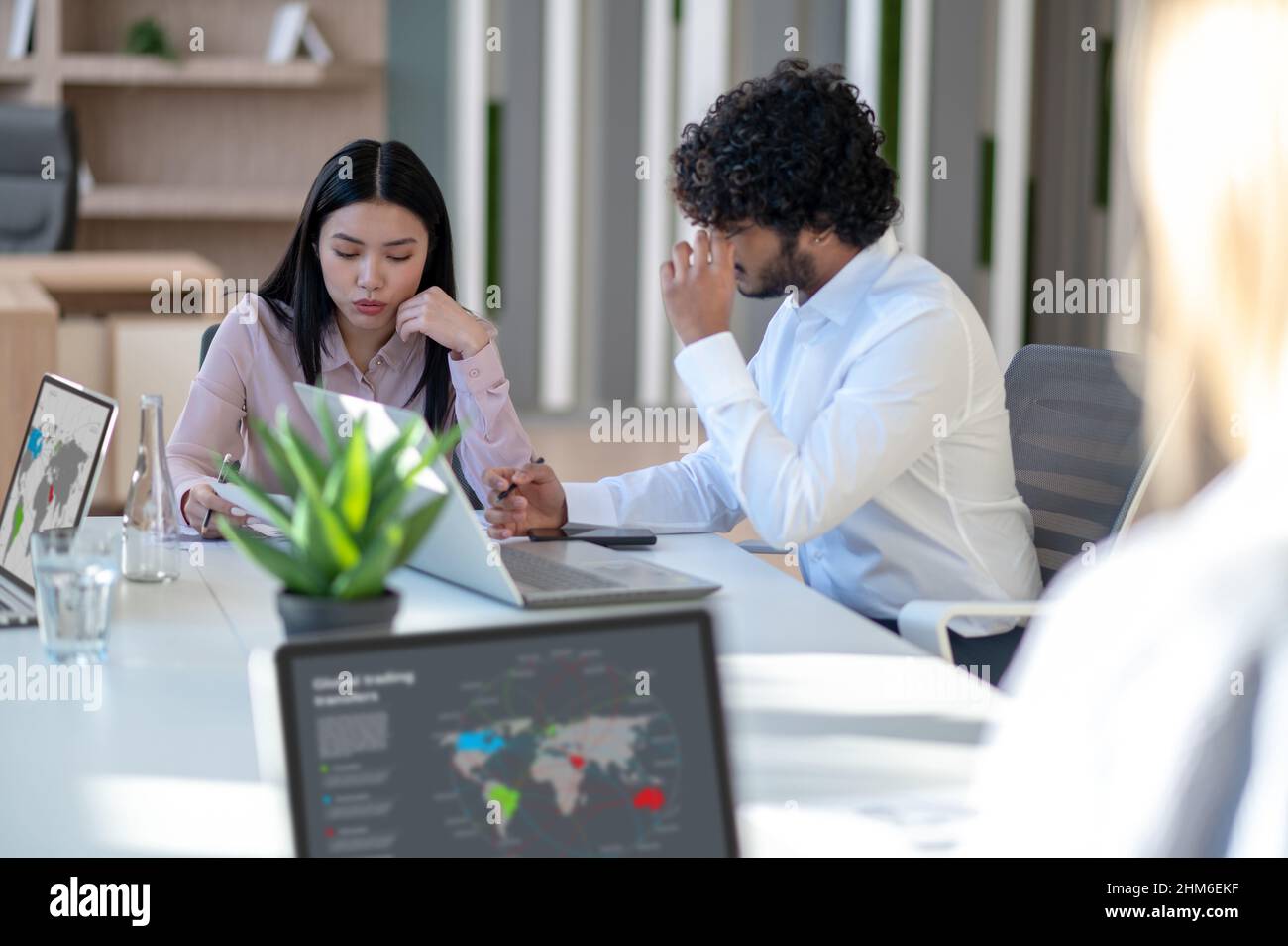 Colleagues working together and looking concentrated Stock Photo - Alamy