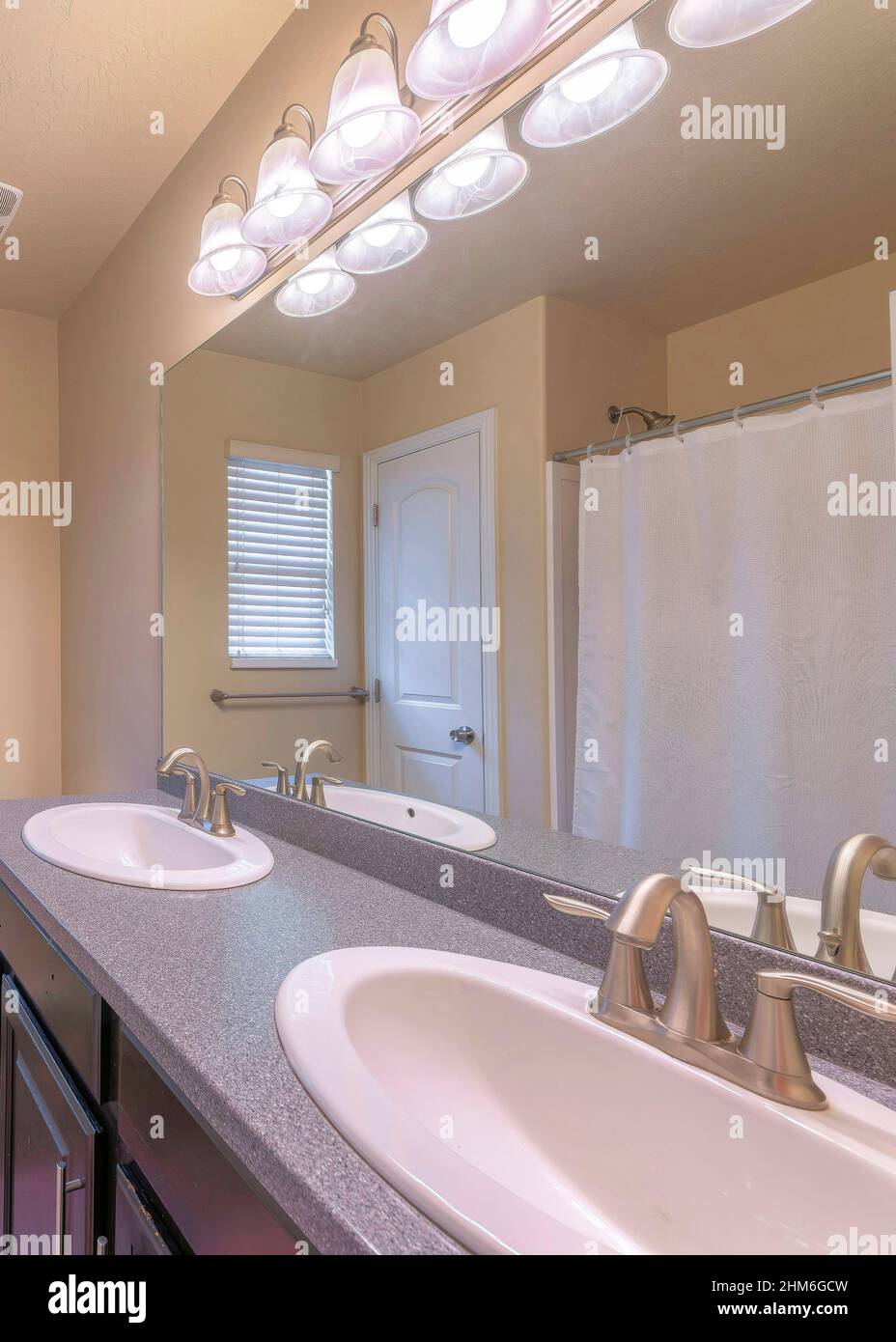 Vertical Bathroom interior with double vanity sink and window Stock ...
