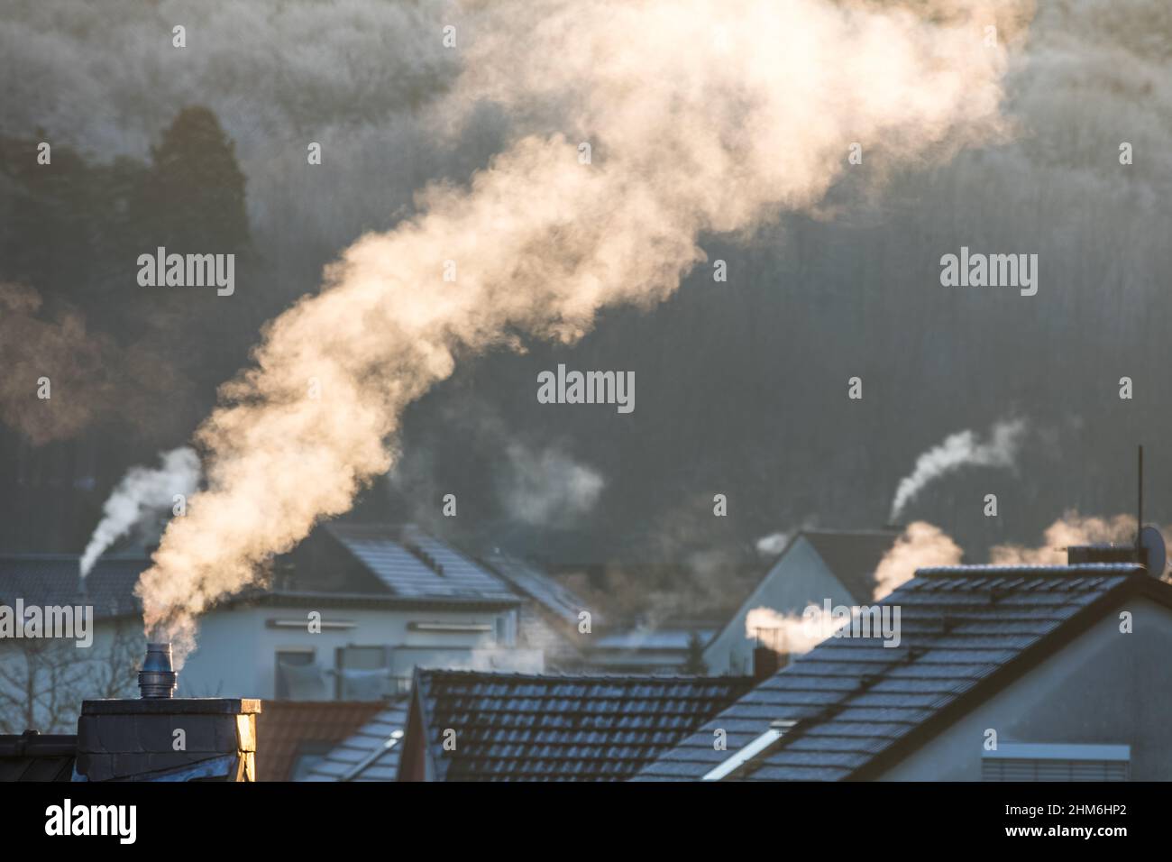 Daylight shot of countryside houses with smoke coming out from the ...