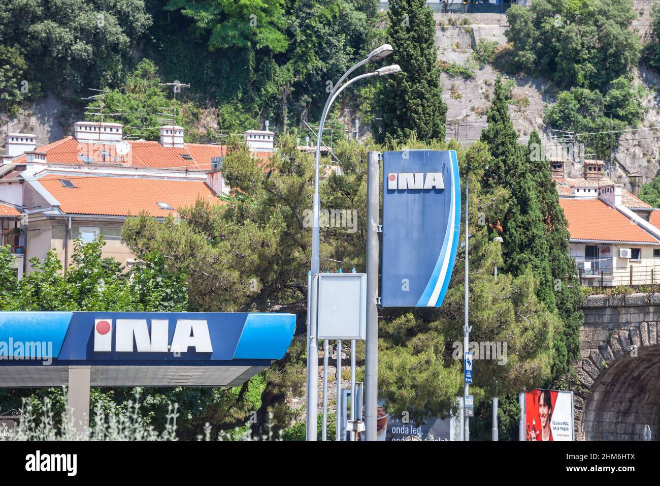 Picture of a sign with the logo of INA in front of a gas station in ...