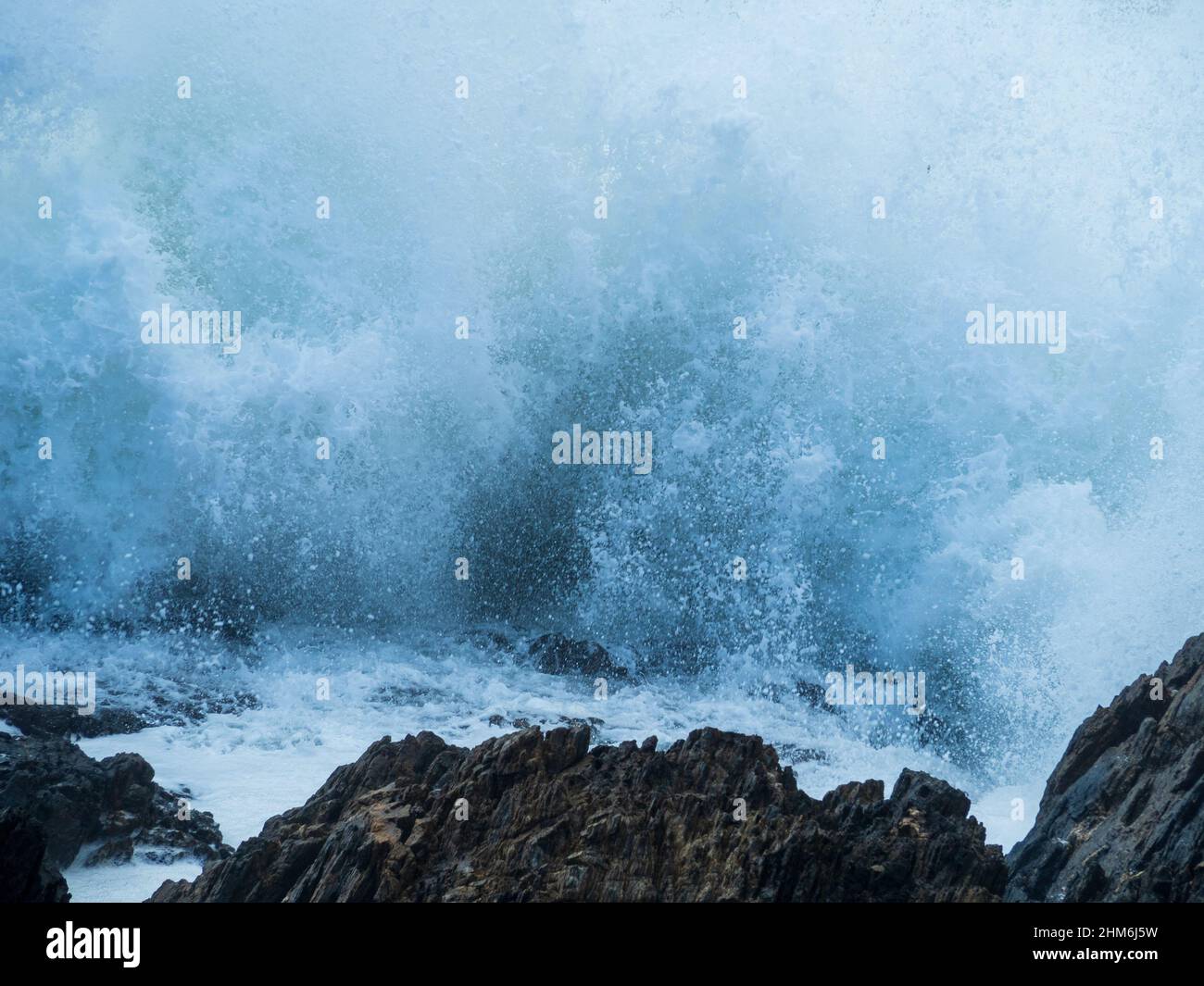 Ocean Waves, closeup of water smashing into and crashing over rocks at ...