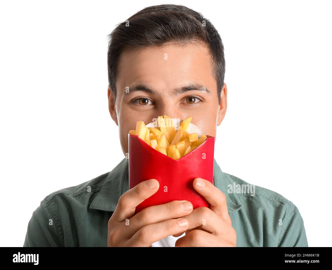 Handsome young man with french fries on white background Stock Photo ...