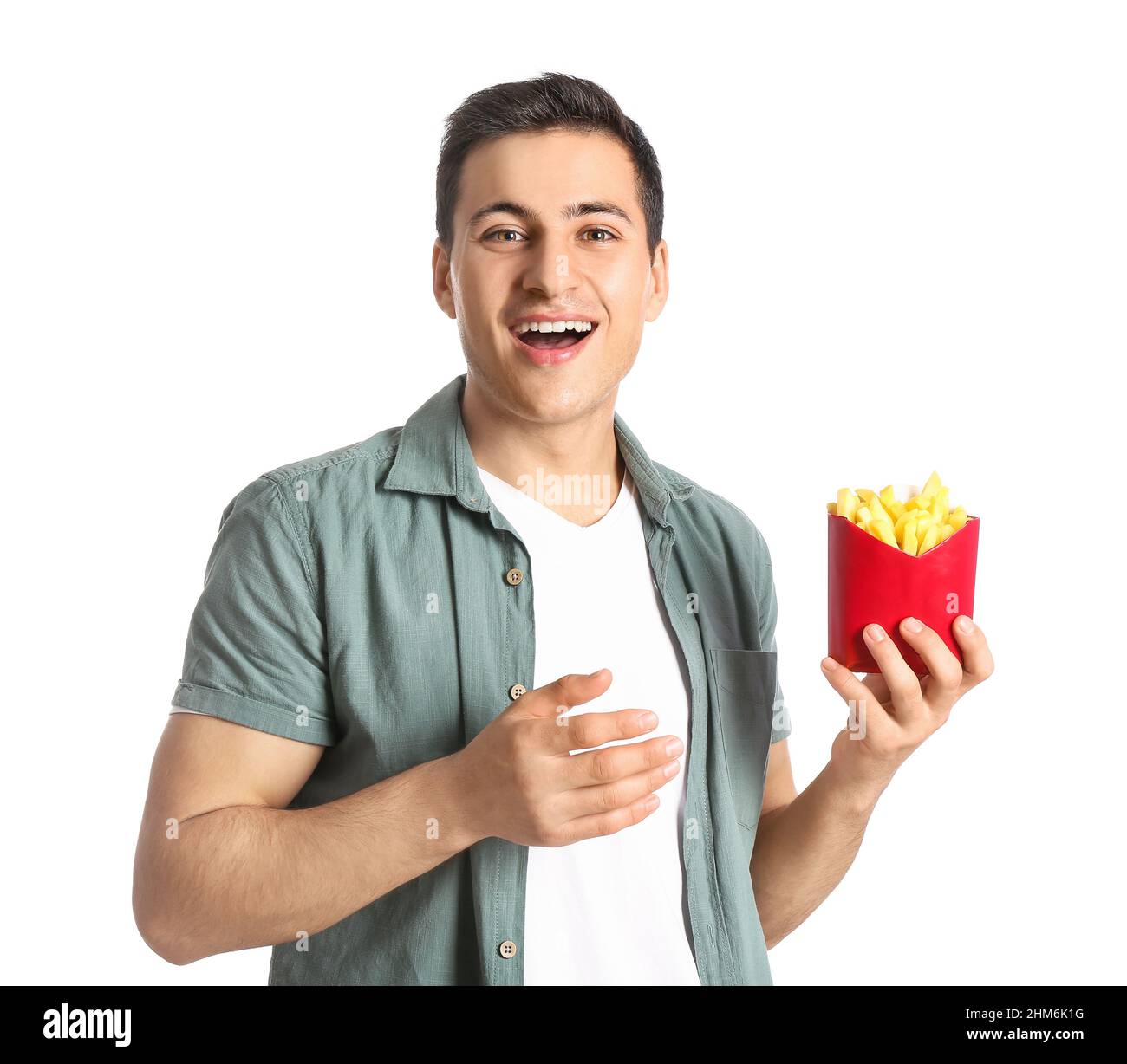 Happy young man with french fries on white background Stock Photo - Alamy