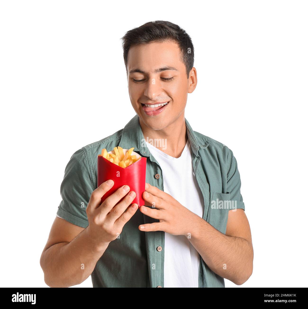 Handsome young man with french fries on white background Stock Photo ...