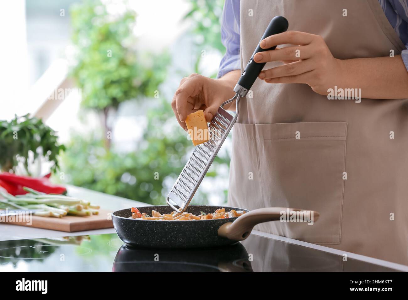 Grating cheese into sauce hi-res stock photography and images - Alamy