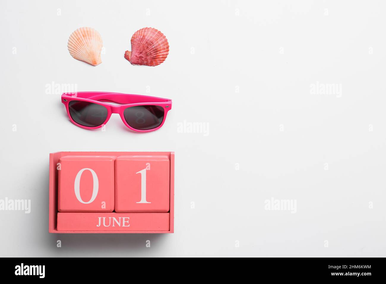 Calendar with date JUNE 1, sunglasses and seashells on white background ...