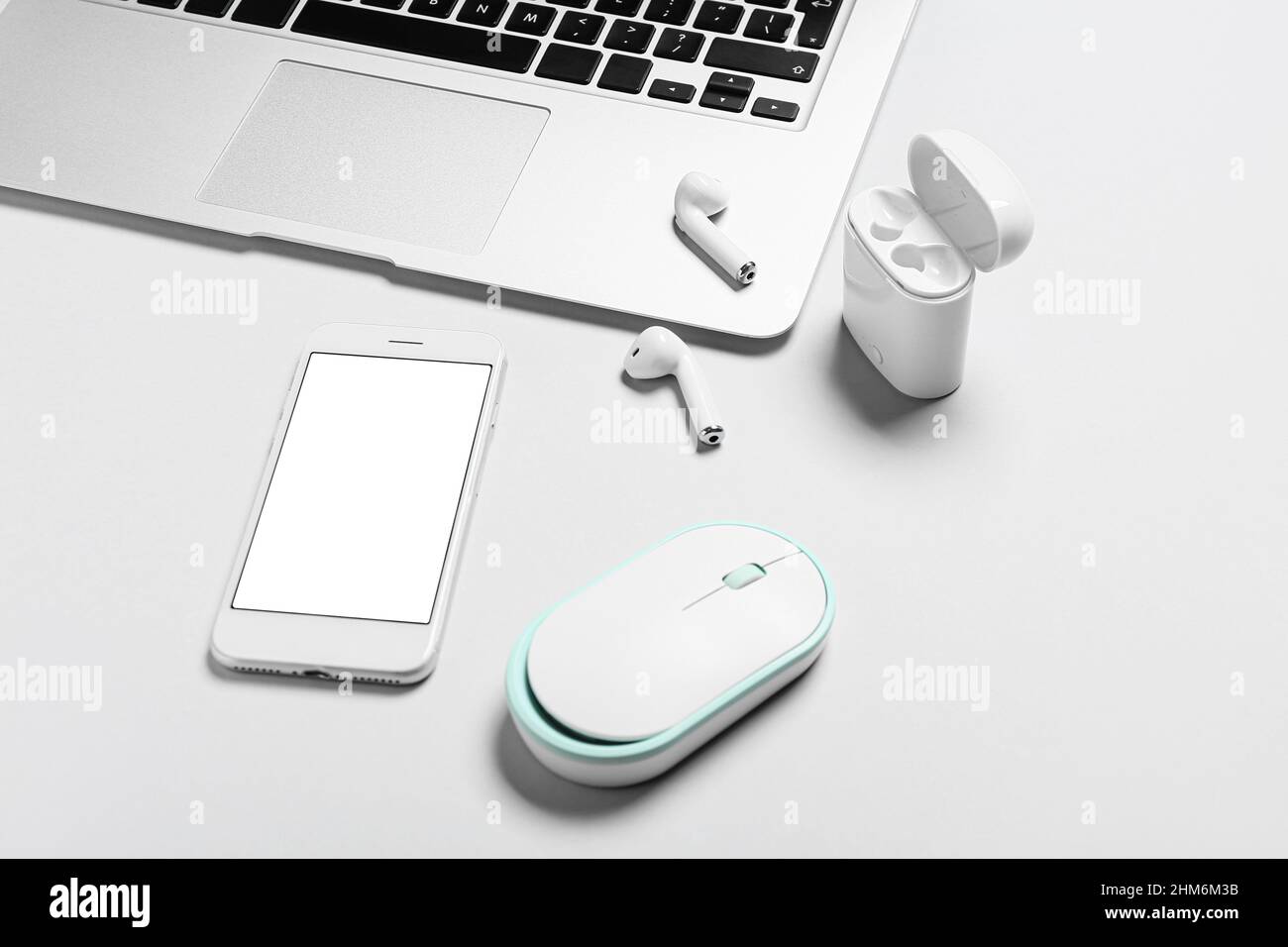 Mobile phone, laptop, earphones and PC mouse on white background Stock ...