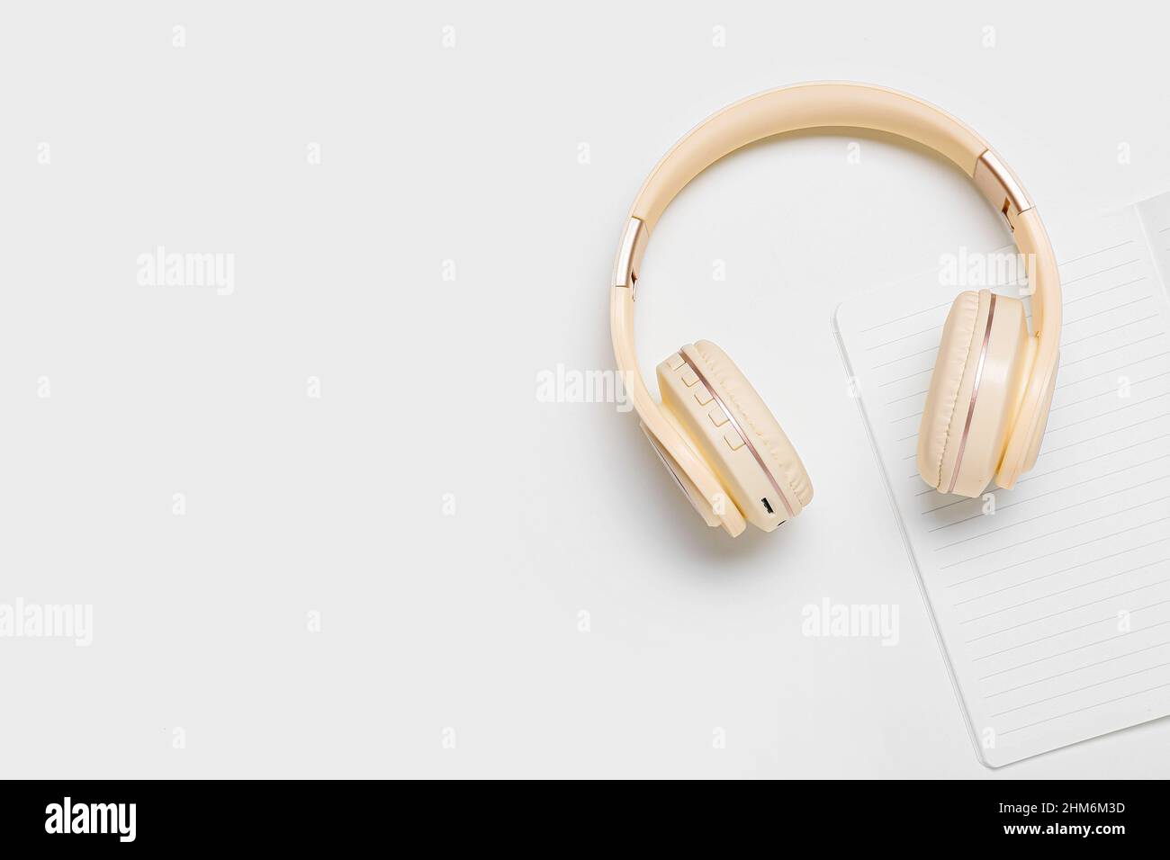 Modern headphones and notebook on white background Stock Photo - Alamy