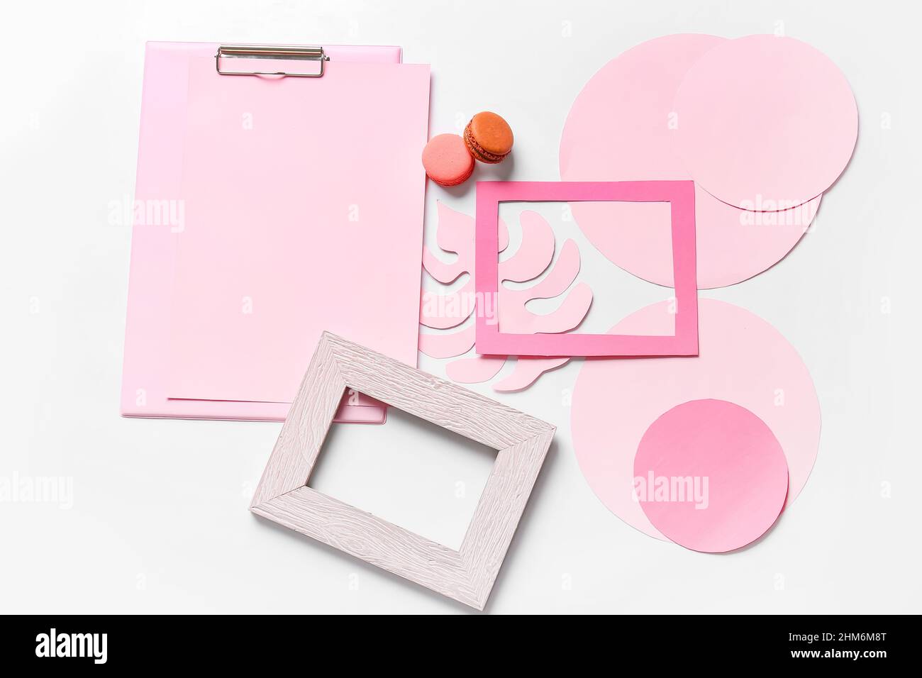 Composition with blank sheet of paper, empty picture frame and cookies ...