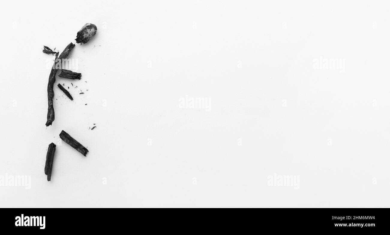 Completely burnt out match showing person on white background ...