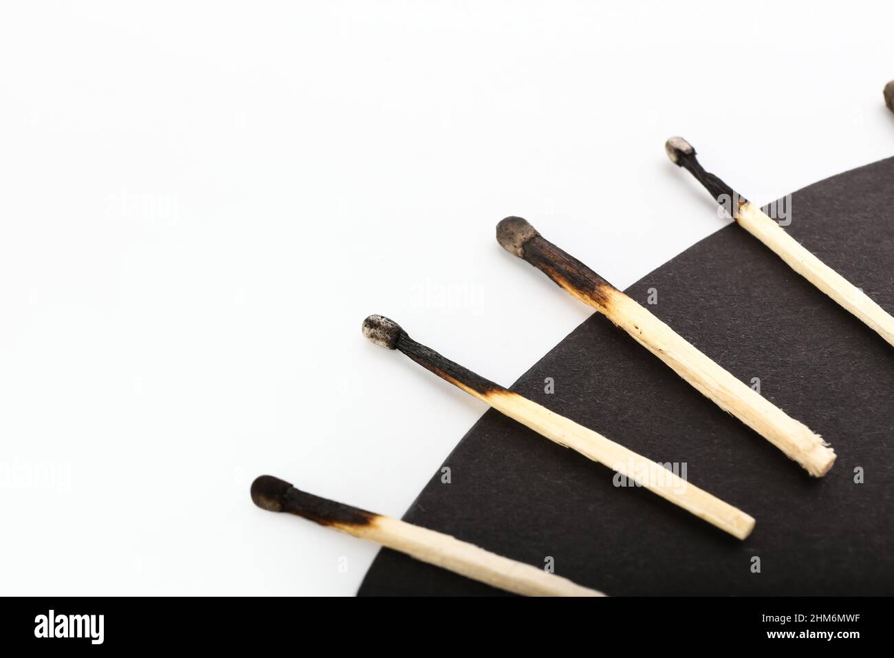 Burnt matches on white and black background, closeup. Concept of work ...
