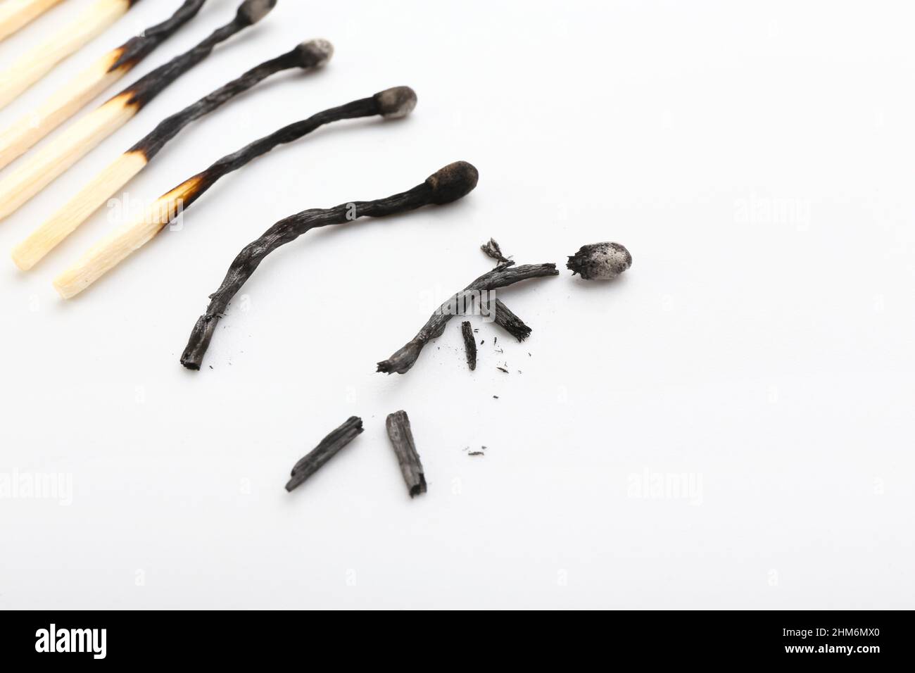Burnt matches on white background, closeup. Different life stages ...