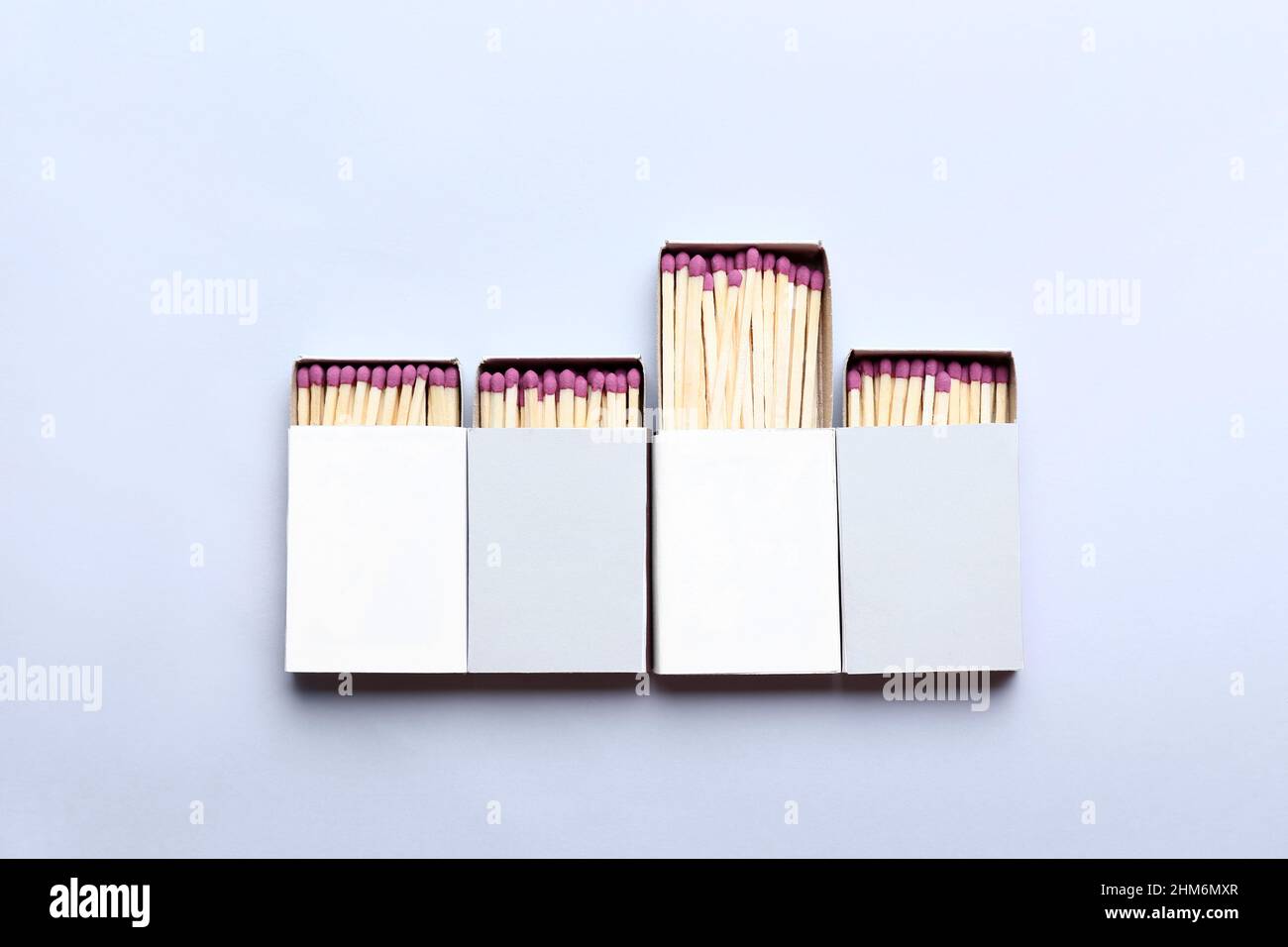 Different matchboxes with matches on grey background Stock Photo - Alamy
