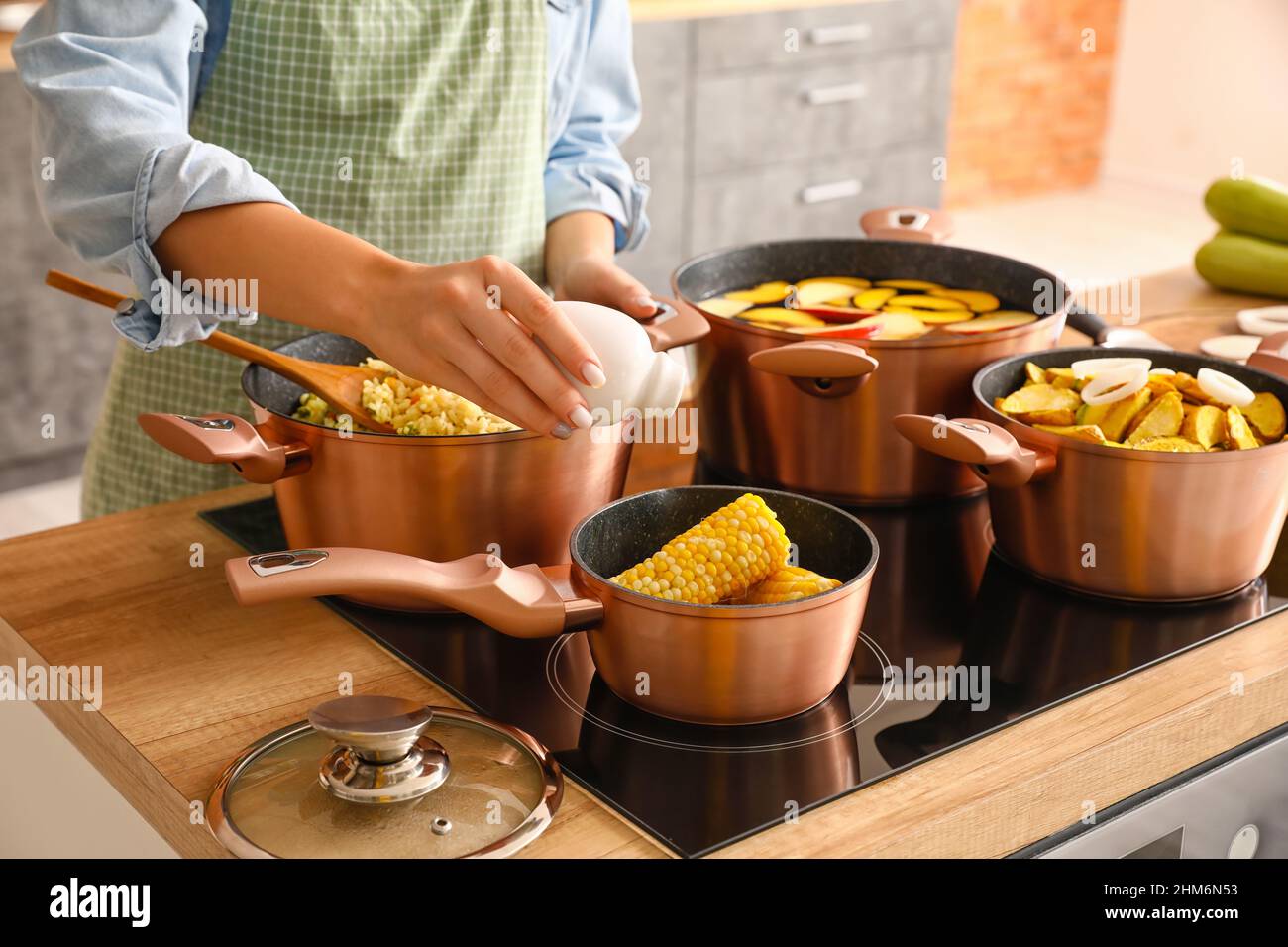 Woman cooking delicious dinner in kitchen Stock Photo - Alamy
