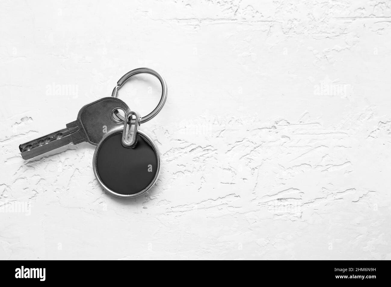 Key with stylish keychain on white background Stock Photo - Alamy