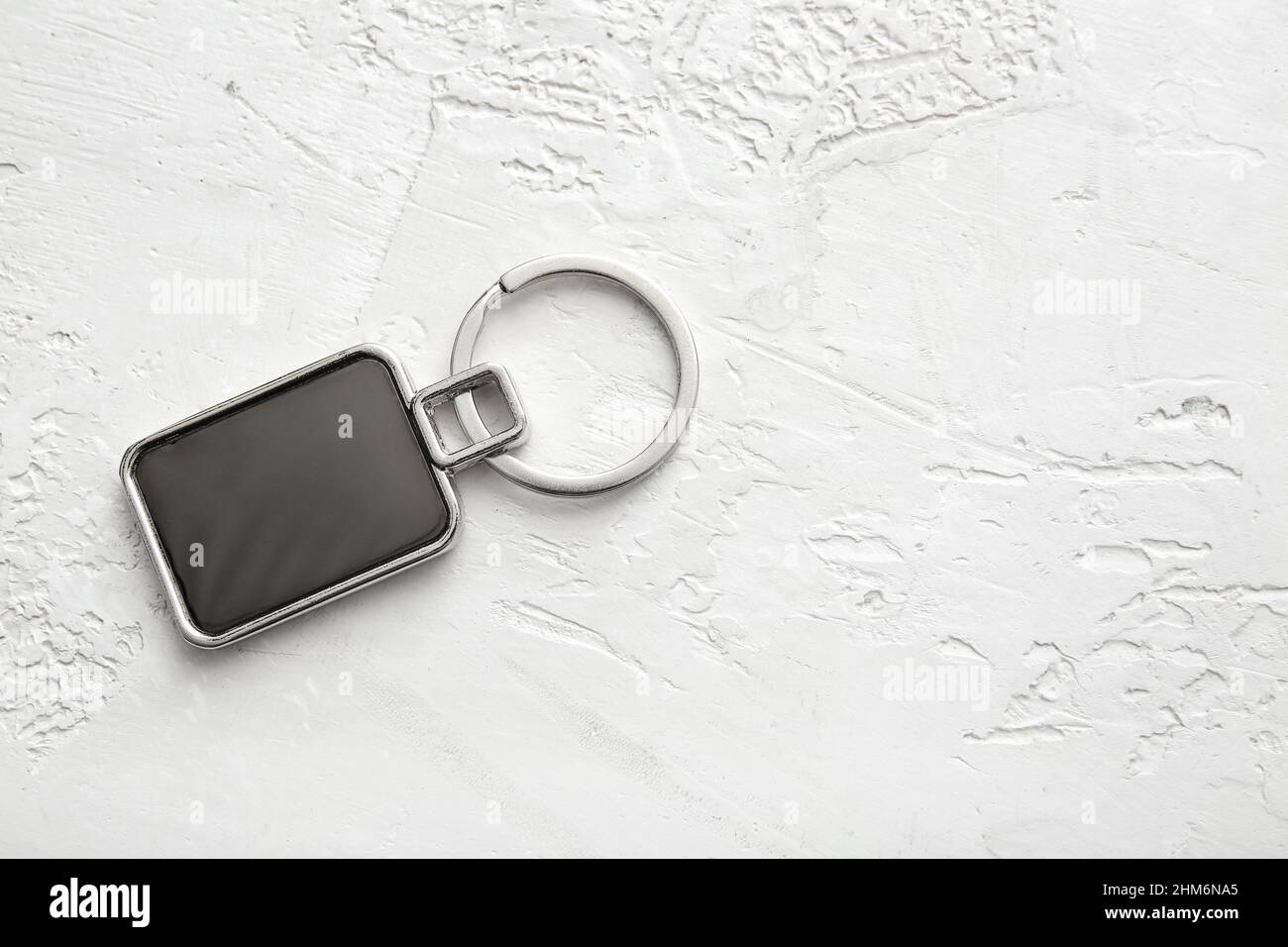 Stylish square keychain on white background Stock Photo - Alamy