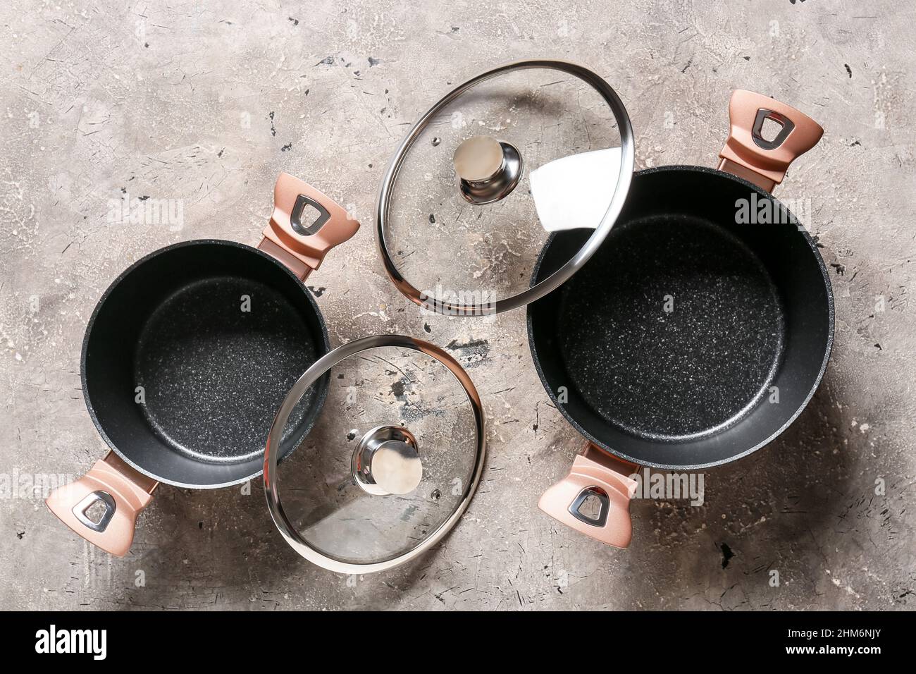 Cooking pots and lids on grunge background Stock Photo - Alamy