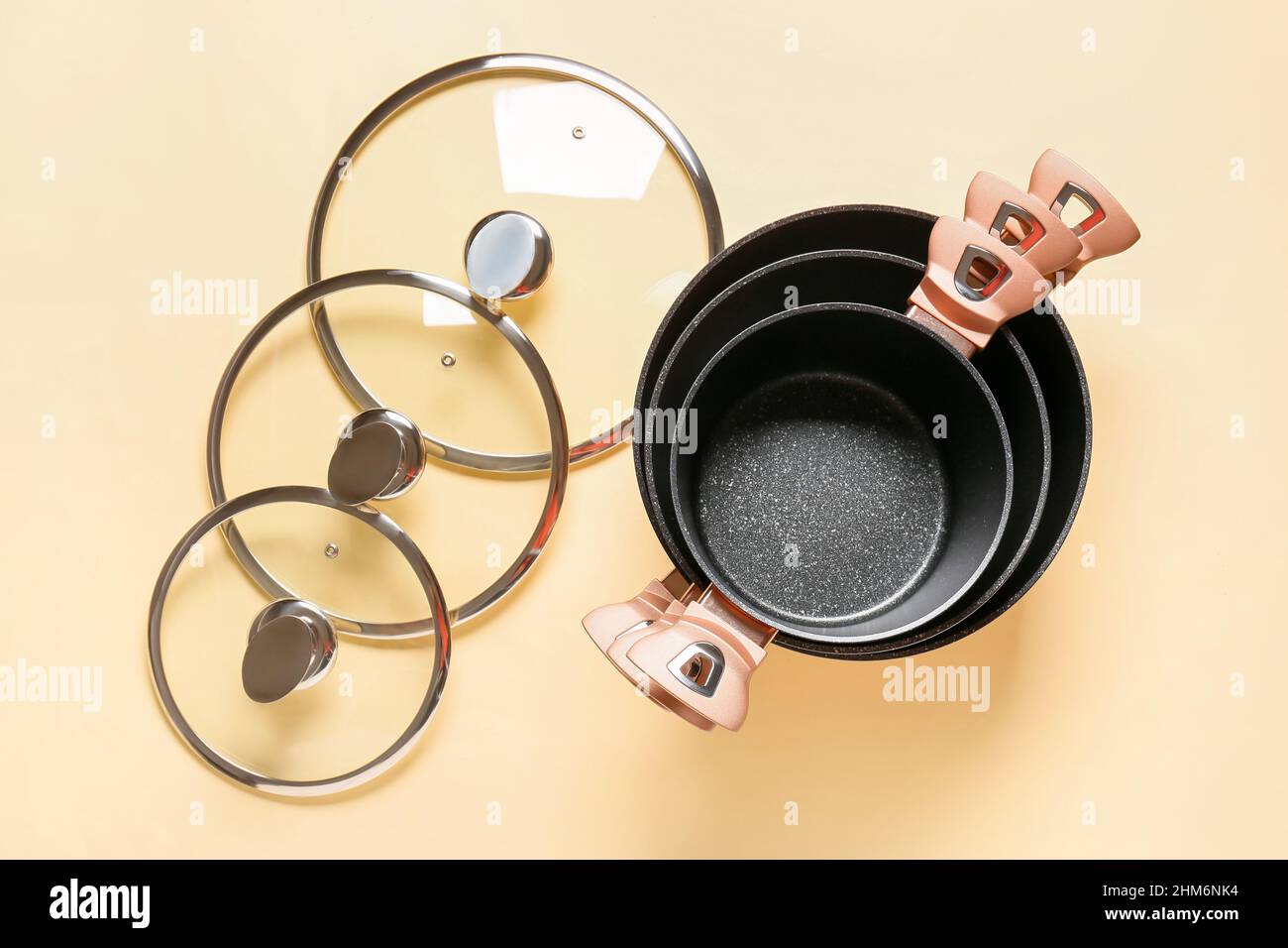 Cooking pots and lids on color background Stock Photo - Alamy