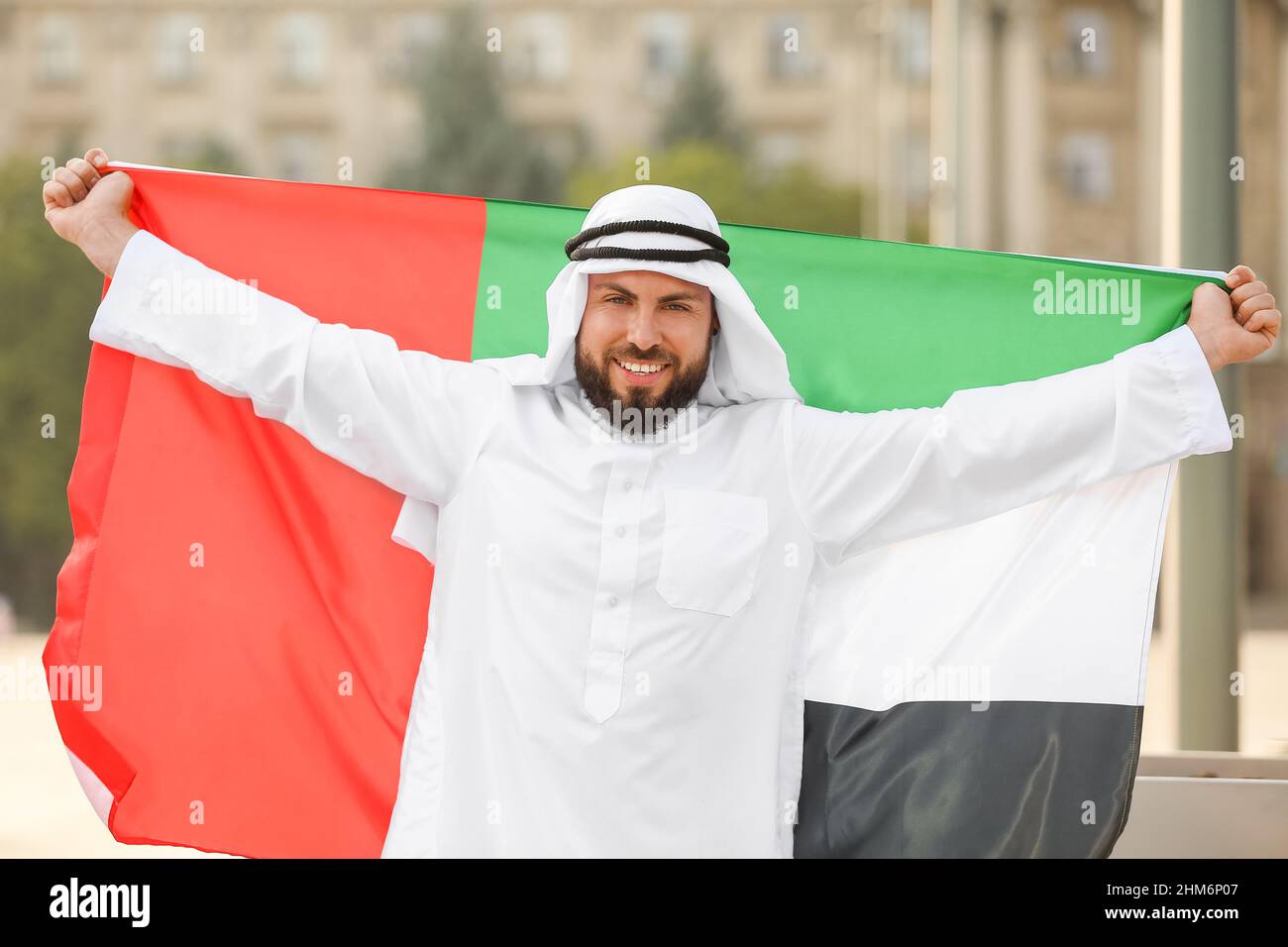 Smiling Muslim man with UAE flag outdoors Stock Photo - Alamy