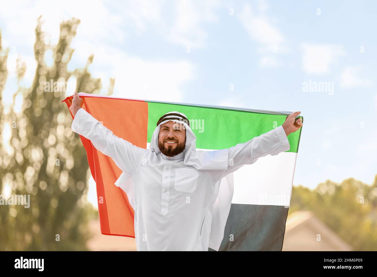 Handsome Muslim man with UAE flag outdoors Stock Photo - Alamy
