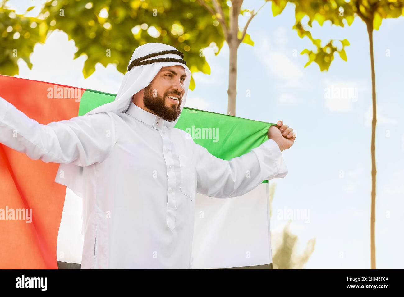 Smiling Muslim man with UAE flag outdoors Stock Photo - Alamy